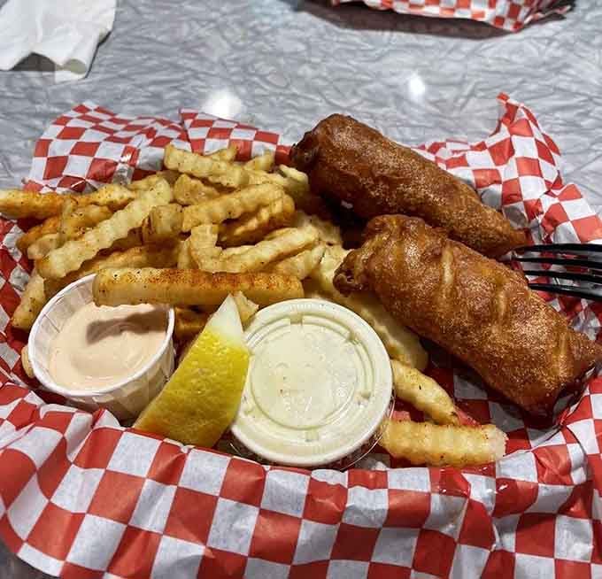 Fish and chips done right, with crinkle fries, lemon, and two dipping sauces for maximum coastal satisfaction.