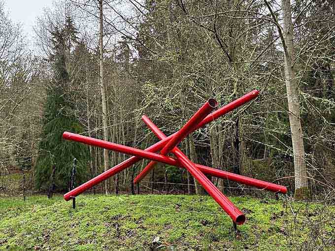 Bold, red, and completely unapologetic, this sculpture bursts through the quiet forest like a jazz trumpet solo at a library reading hour.