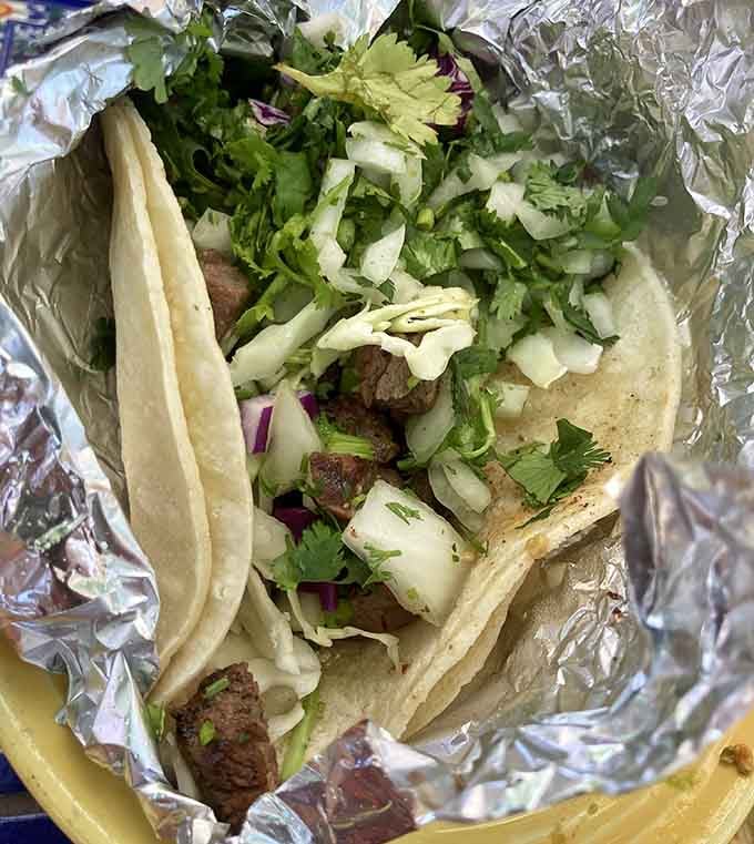 Tender grilled meat, fresh cilantro, and onion tucked into soft corn tortillas, proof that simple is often perfect.
