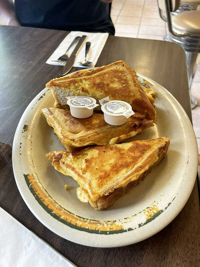 Golden, crispy French toast stacked high with butter cups ready. Simple, honest, and completely satisfying.
