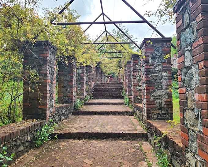 A brick pergola walkway straight out of a secret garden. Minus the secrets, plus the history.