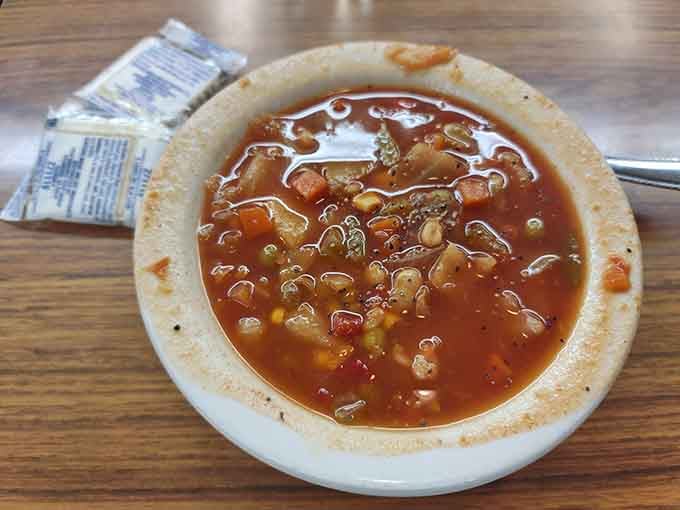 Homemade vegetable soup that looks like someone's grandmother made it, and that is absolutely a compliment.