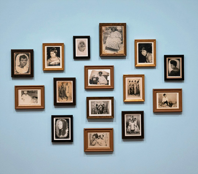 Framed photographs arranged on a soft blue wall, each one carrying a story that deserves far more than a glance.