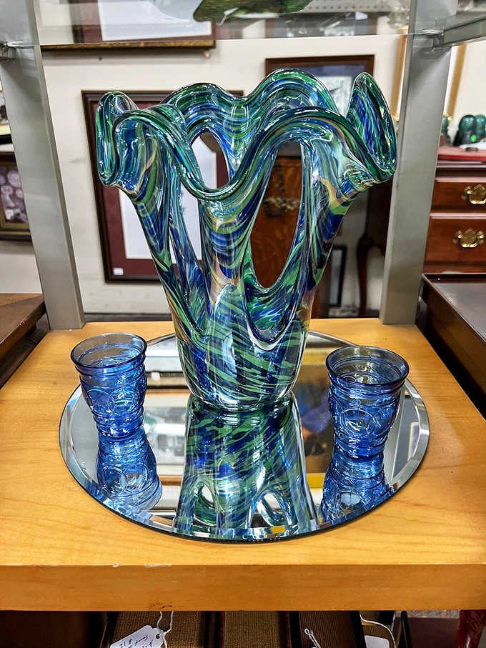 That swirling art glass vase is the kind of piece that stops you mid-stride and makes you forget what you came in for.