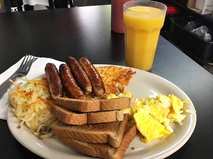 Sausage links, fluffy scrambled eggs, hash browns, toast, and a tall glass of OJ. This is what a proper morning looks like.