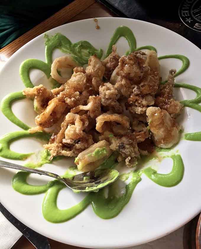 Firecracker wasabi calamari plated with swirls of bright green sauce, because dinner should always have a little drama.