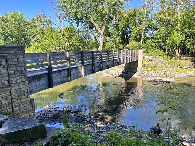 The bridge over Salt Creek offers front-row seats to nature's daily show, where water meets woodland perfectly.