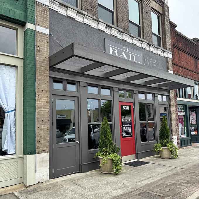 That bold red door at The Rail Public House isn't just an entrance, it's a standing invitation you'd be foolish to decline.