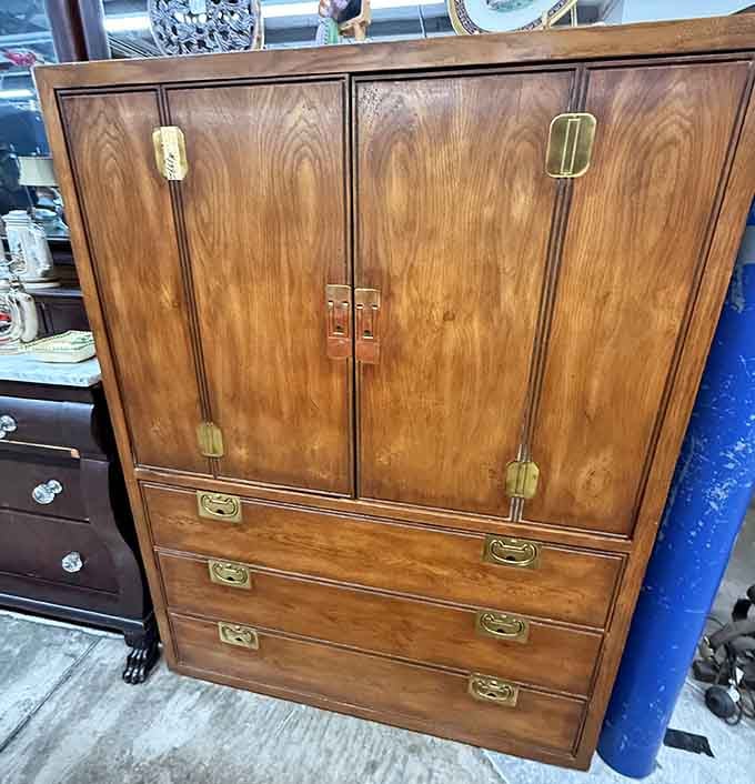 That wooden cabinet with brass hardware is just waiting to anchor someone's living room with authentic vintage charm.