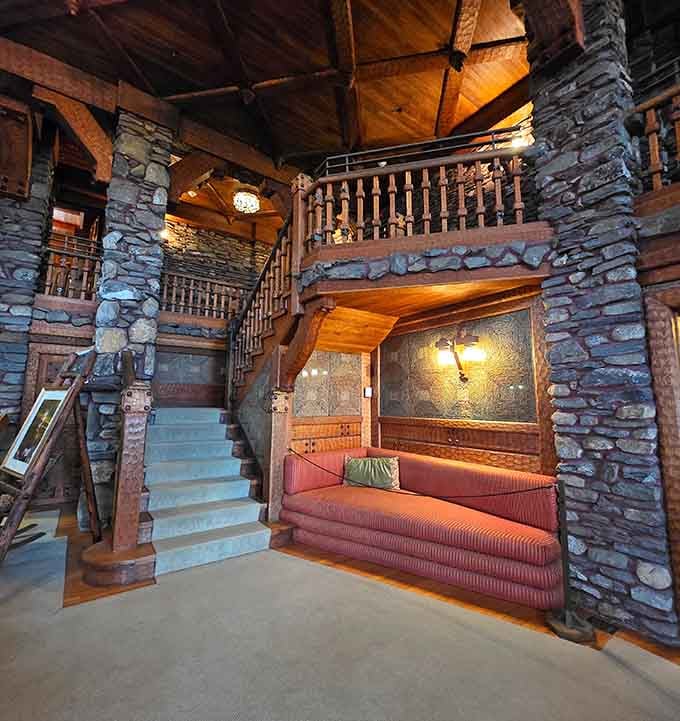 The staircase alone is worth the drive. Warm wood, stacked stone, and a sofa that's seen better centuries.