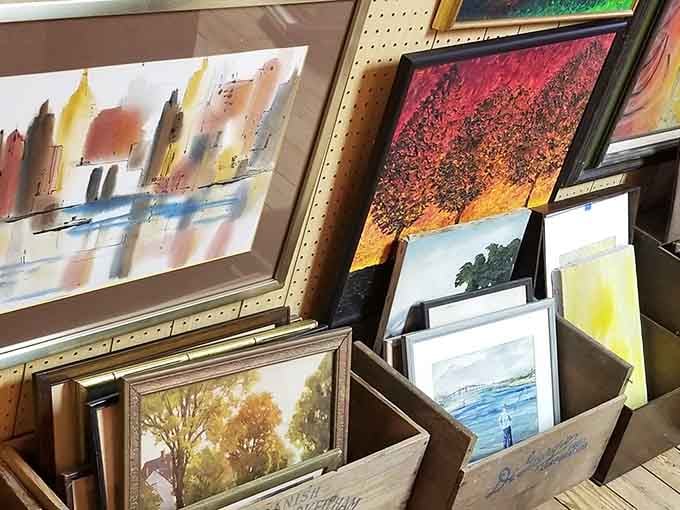 Framed paintings stacked like chapters in a book, each one somebody's vision of the world worth keeping.