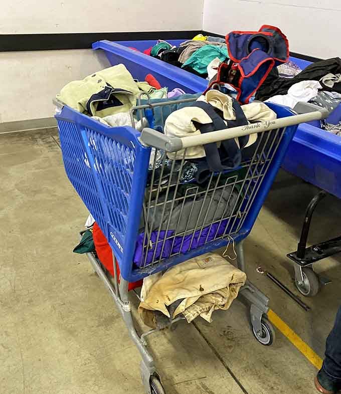 A cart piled high with clothing finds, the universal symbol of a very successful afternoon at the outlet.