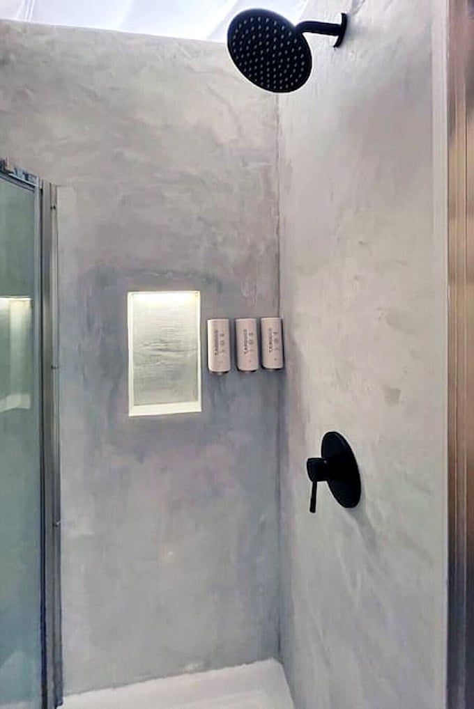 A polished concrete shower with a rainfall head. Roughing it has never looked this effortlessly sophisticated.