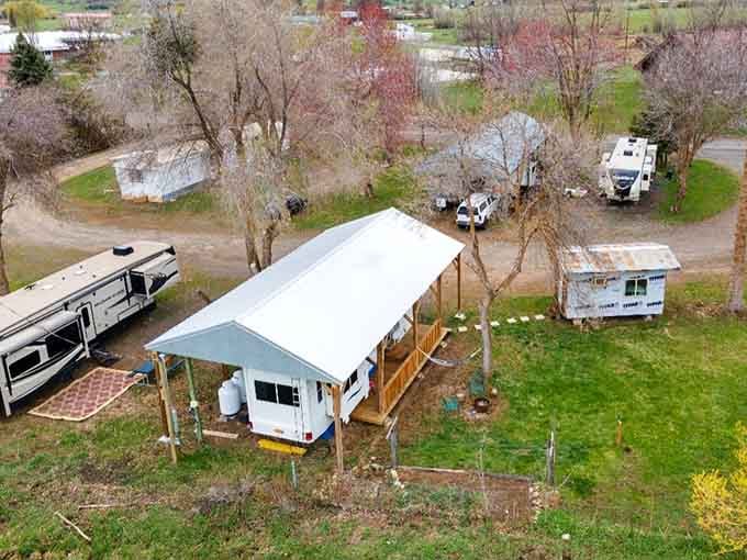Aerial views of cozy cabins, RVs tucked among bare spring trees, and gravel paths that whisper "slow down, you're on vacation."
