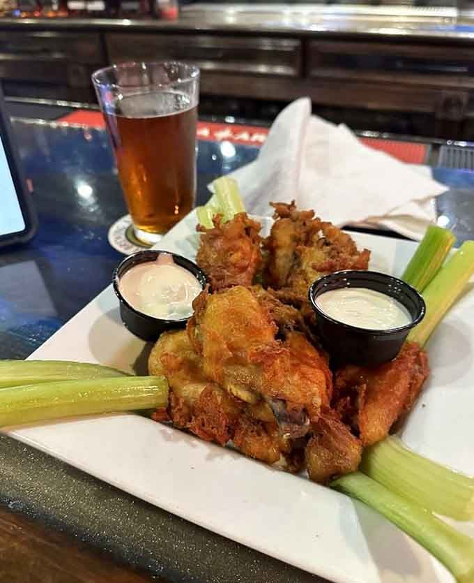 These wings come with celery, two dipping sauces, and the kind of crispy skin that makes you forget your manners.