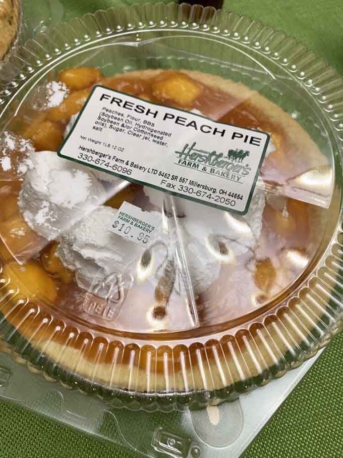 Fresh peach pie topped with whipped cream &mdash; summer in Ohio never looked this good sitting under a plastic dome.