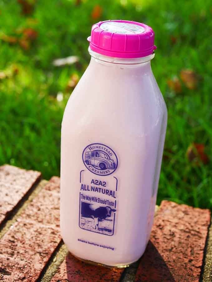 Sunshine, green grass, and a pink-capped bottle of strawberry milk that makes every other beverage feel deeply inadequate by comparison.