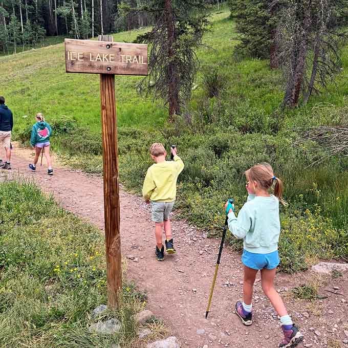 The Ice Lake Trail sign marks the beginning of something your legs will complain about and your soul will never forget.