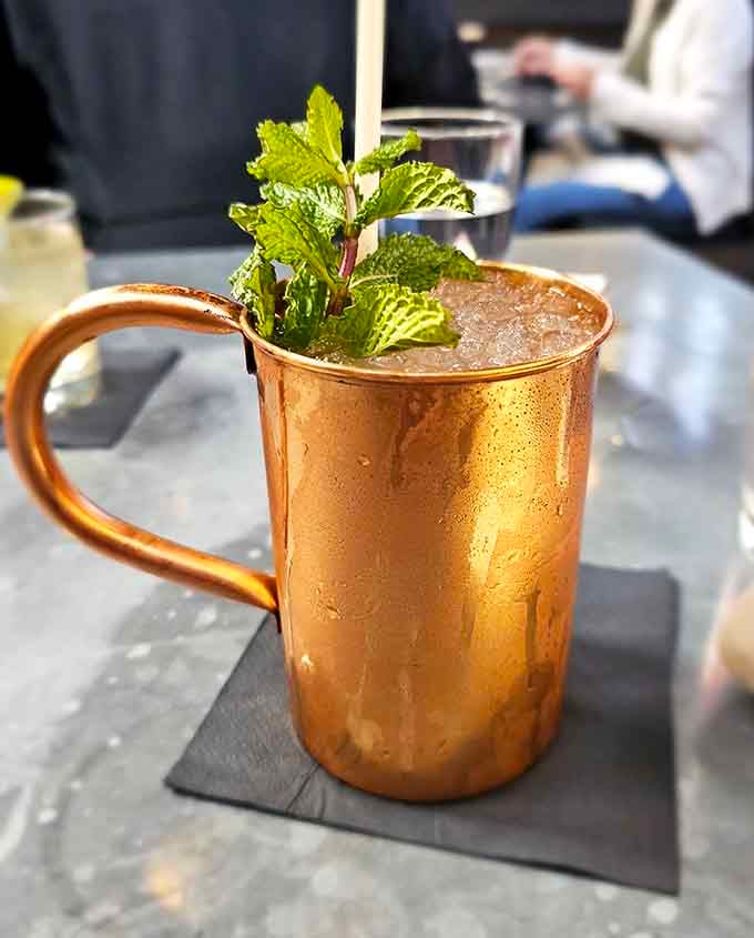 A copper mug full of something cold and refreshing, served inside a building that's been keeping things cool since 1927.