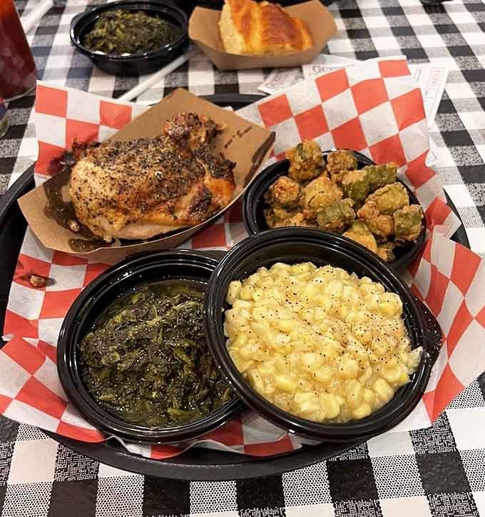 Herb-roasted chicken surrounded by creamed corn and slow-cooked greens, a plate that looks like Sunday dinner at its finest.