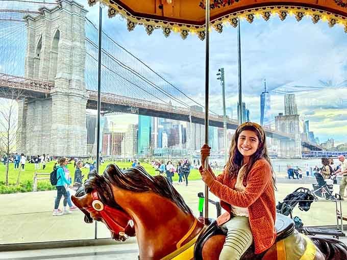 Gripping the pole, Brooklyn Bridge behind her, this is the face of someone having the best day.