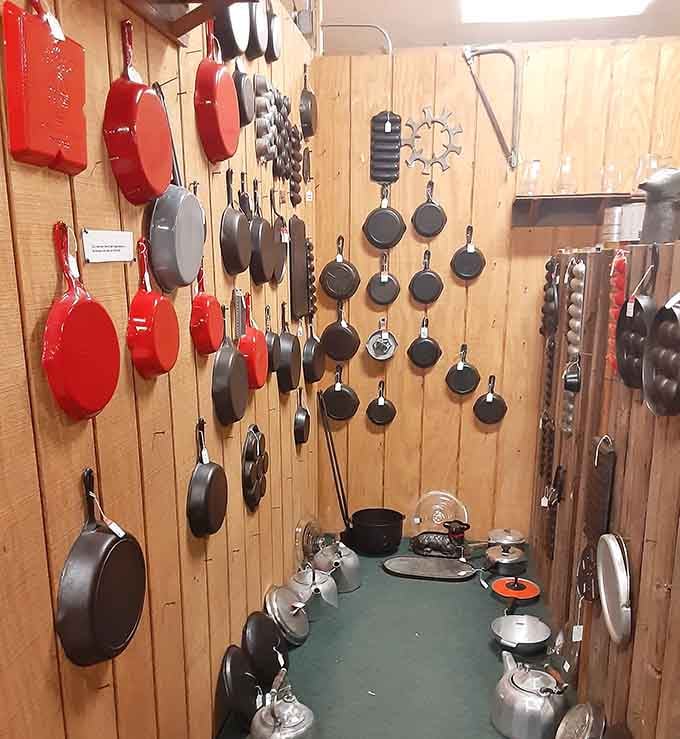 Cast iron skillets hanging like a culinary hall of fame, each one seasoned by decades of family dinners.