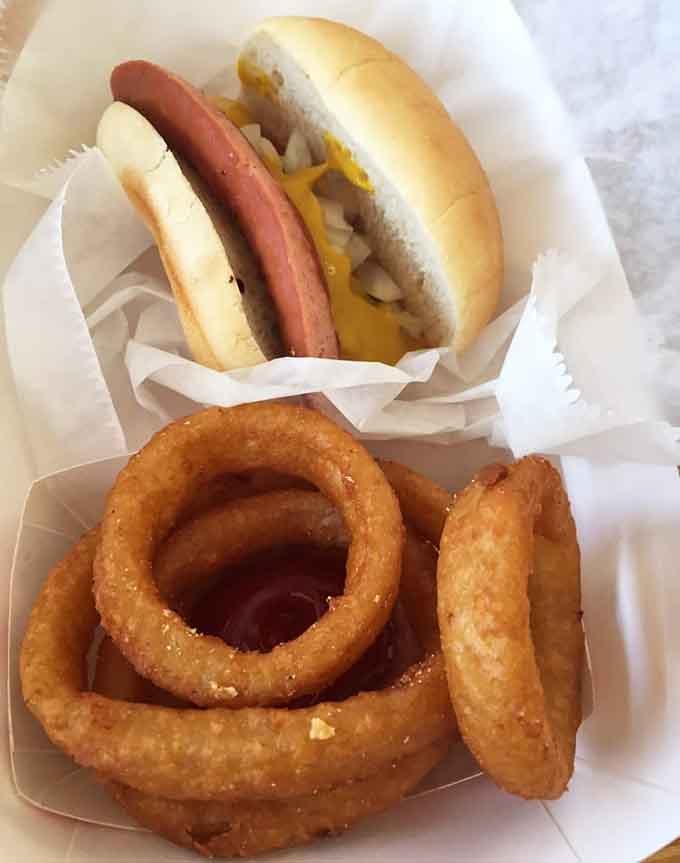 Golden onion rings that could make a grown person weep with joy, paired with frankfurter perfection.