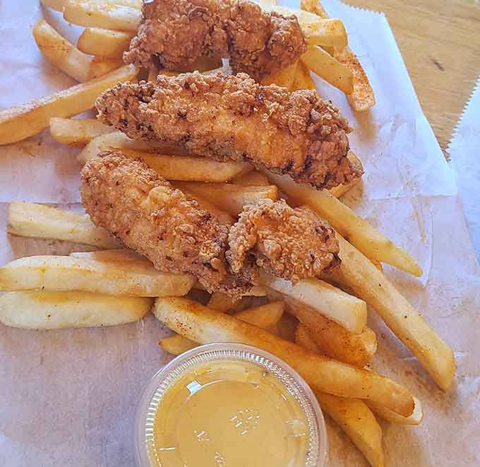 Chicken strips and fries arranged like they're auditioning for a food magazine cover, and honestly, they'd get the job.