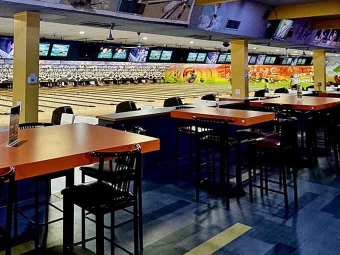 High-top tables overlook the lanes, ideal for eating, drinking, and pretending you planned that split.