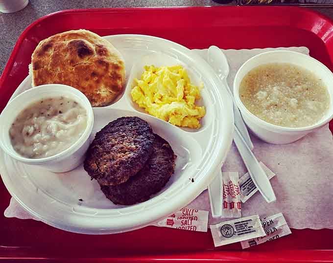 Sausage, eggs, grits, and a biscuit create the breakfast dream team on one glorious red tray.