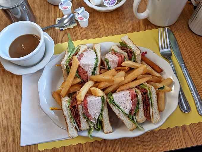A proper turkey club with fries and soup proves lunch here is just as serious as breakfast.