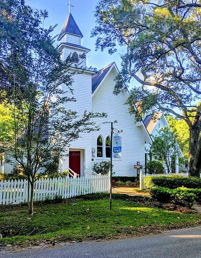 That bright red door against crisp white wood is the kind of detail that stops you mid-stride.