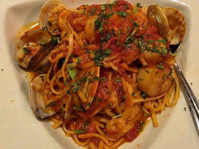 Clams, shrimp, and scallops tangled in a gorgeous tomato sauce, this pasta dish is basically a coastal vacation on a plate.