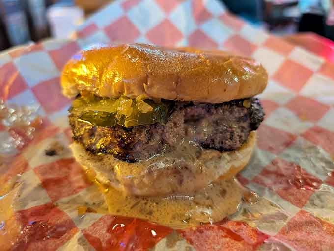 Molten cheese oozing from every angle, this close-up of the Juicy Lucy is basically a masterpiece that belongs in a museum of delicious decisions.