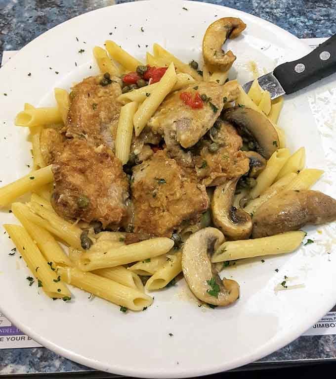 Tender veal piccata over penne with mushrooms and capers, this diner just quietly outcooked half of Italy.