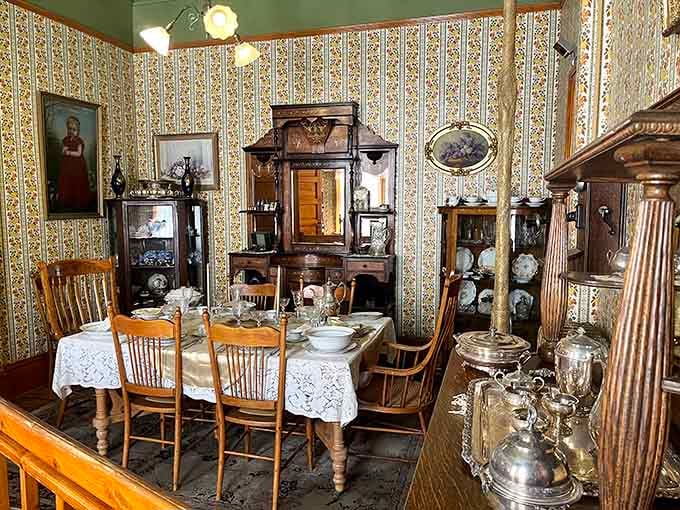 A dining room set with silver and lace, ready for guests who never quite stopped arriving.