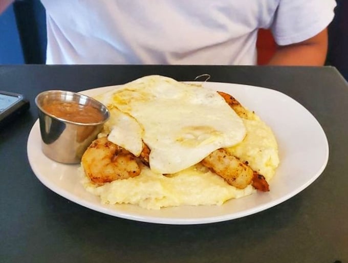 Shrimp, grits, and a fried egg on top. Someone in this kitchen really understands how mornings should feel.