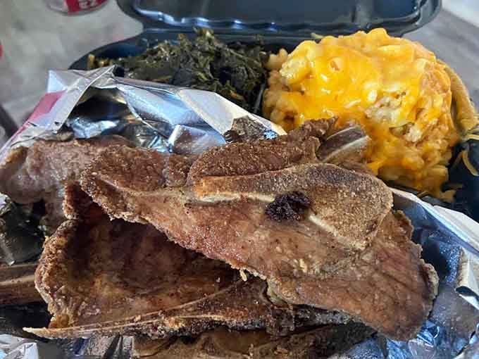 Fried pork chops with greens and mac and cheese. Soul food that means every single word it says.