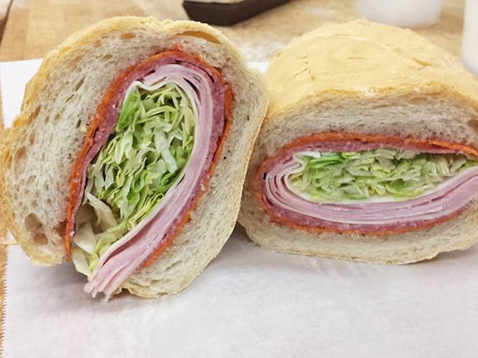 Layers of ham, salami, and fresh lettuce stacked inside house-baked bread, this sandwich means serious, glorious business.