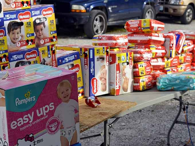 Pampers and Huggies stacked high and proud, because smart parents know a good deal is always worth the detour.
