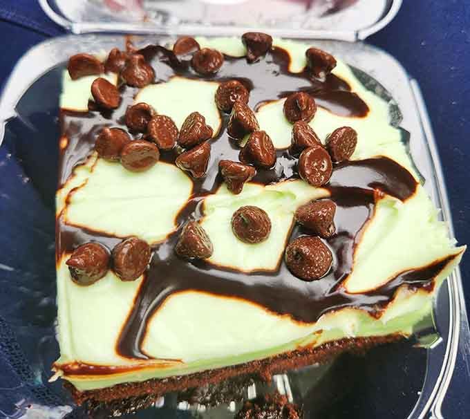 Mint chocolate cheesecake drizzled with chocolate sauce and topped with cereal proves that creativity thrives in the most unexpected kitchens.