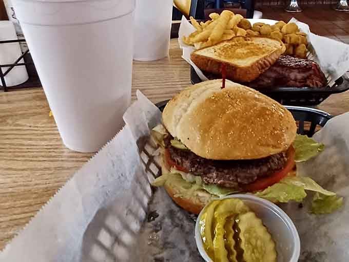 That burger is stacked, confident, and surrounded by pickles, exactly how a great burger should arrive.