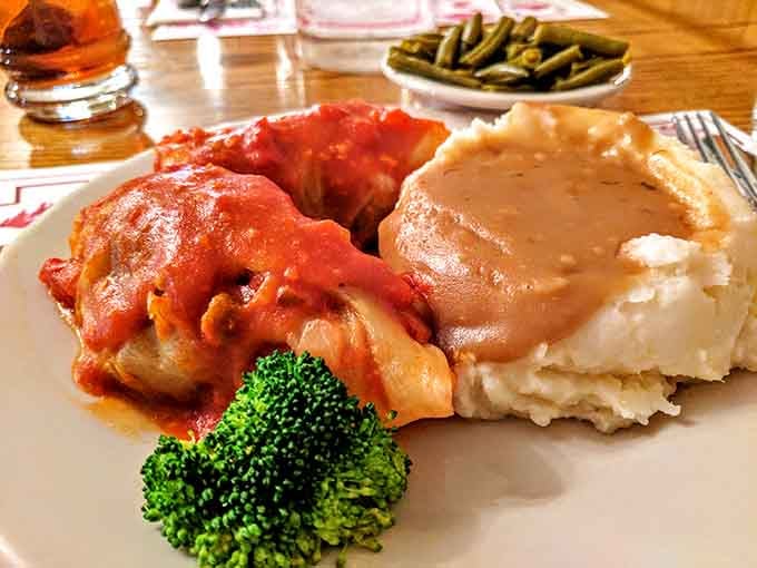 Stuffed cabbage blanketed in tomato sauce beside a cloud of mashed potatoes and gravy, comfort food doesn't get more sincere than this.