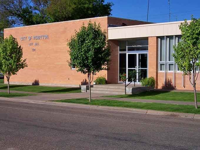 Perryton City Hall sits neat and tidy on a sun-drenched morning, the kind of civic building that actually makes you feel good about local government.