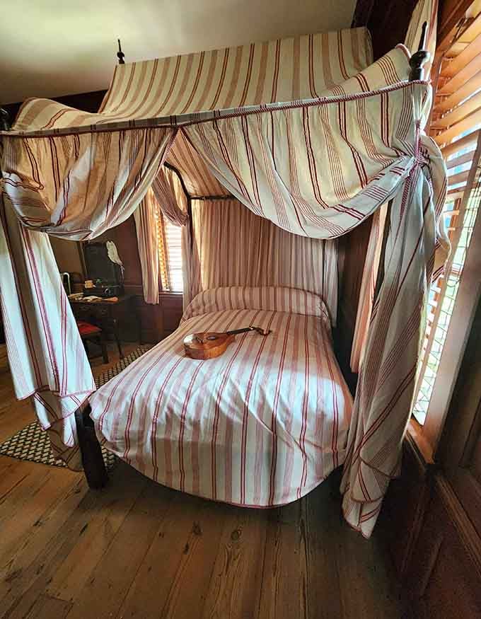 A four-poster canopy bed that makes your modern mattress feel like a complete failure of imagination.