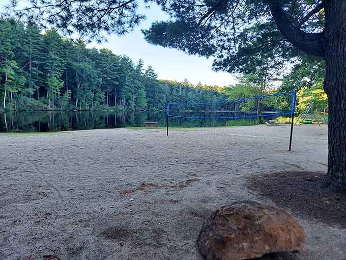 A sandy volleyball court lakeside, where friendly competition meets genuinely spectacular views.