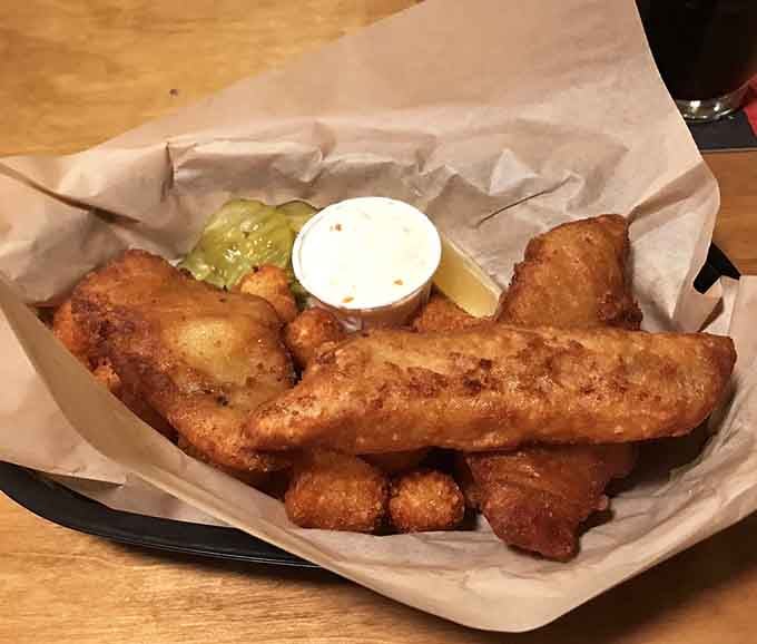 Golden, crispy fried fish with tater tots and a dipping sauce, the kind of basket that makes everything feel right.