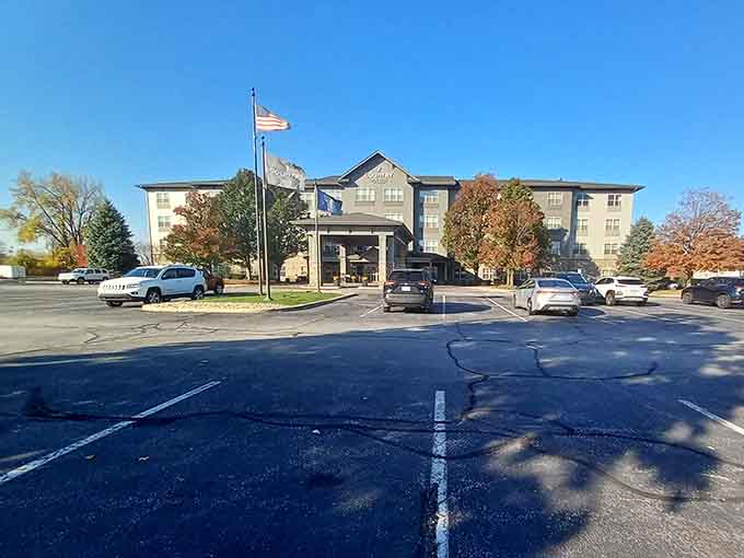 Country Inn and Suites stands tall under a brilliant blue sky, fall foliage framing it like a postcard you'd actually mail.