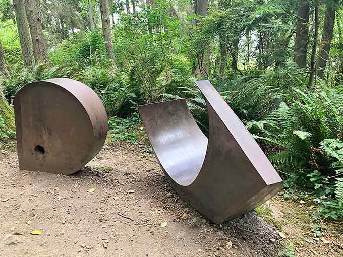 Heavy steel curves sit boldly among the ferns, the kind of sculpture that makes you circle it three times wondering.