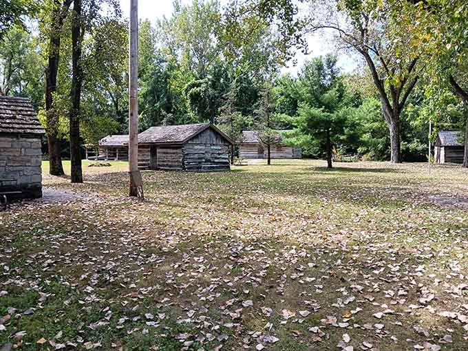 Autumn leaves scattered across the Log Cabin Village grounds make this living history site feel genuinely transported from another century.